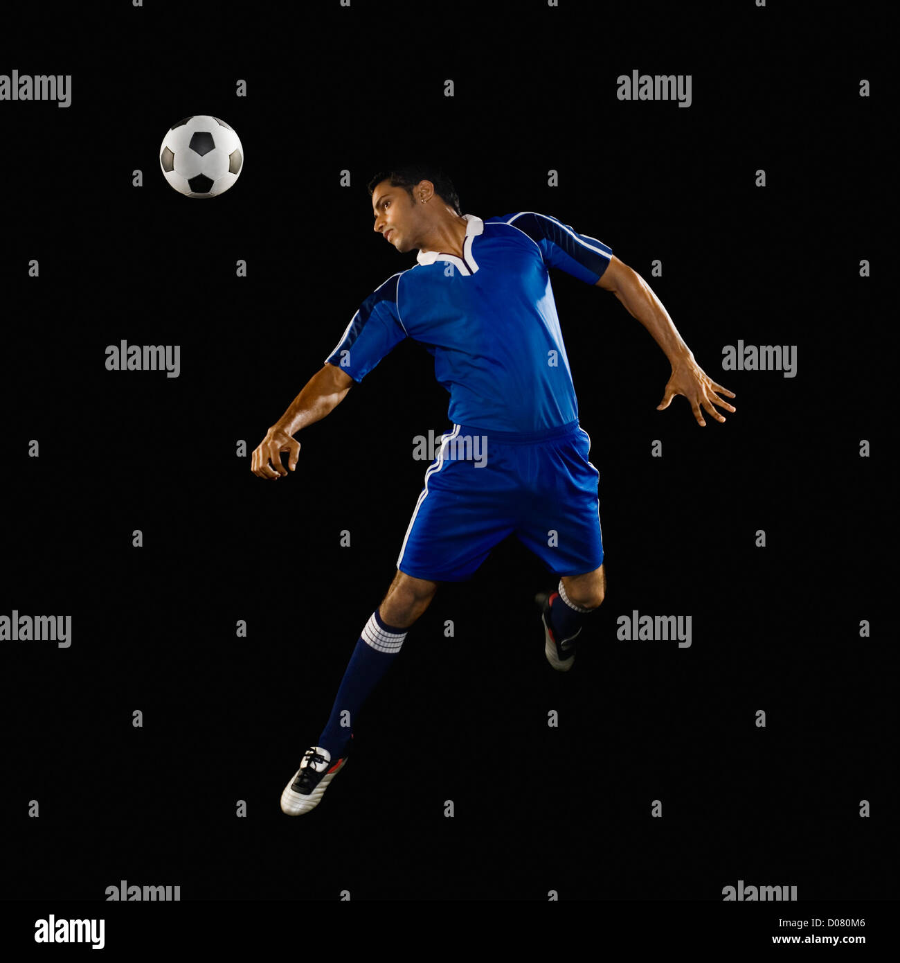 Man heading a soccer ball Stock Photo - Alamy