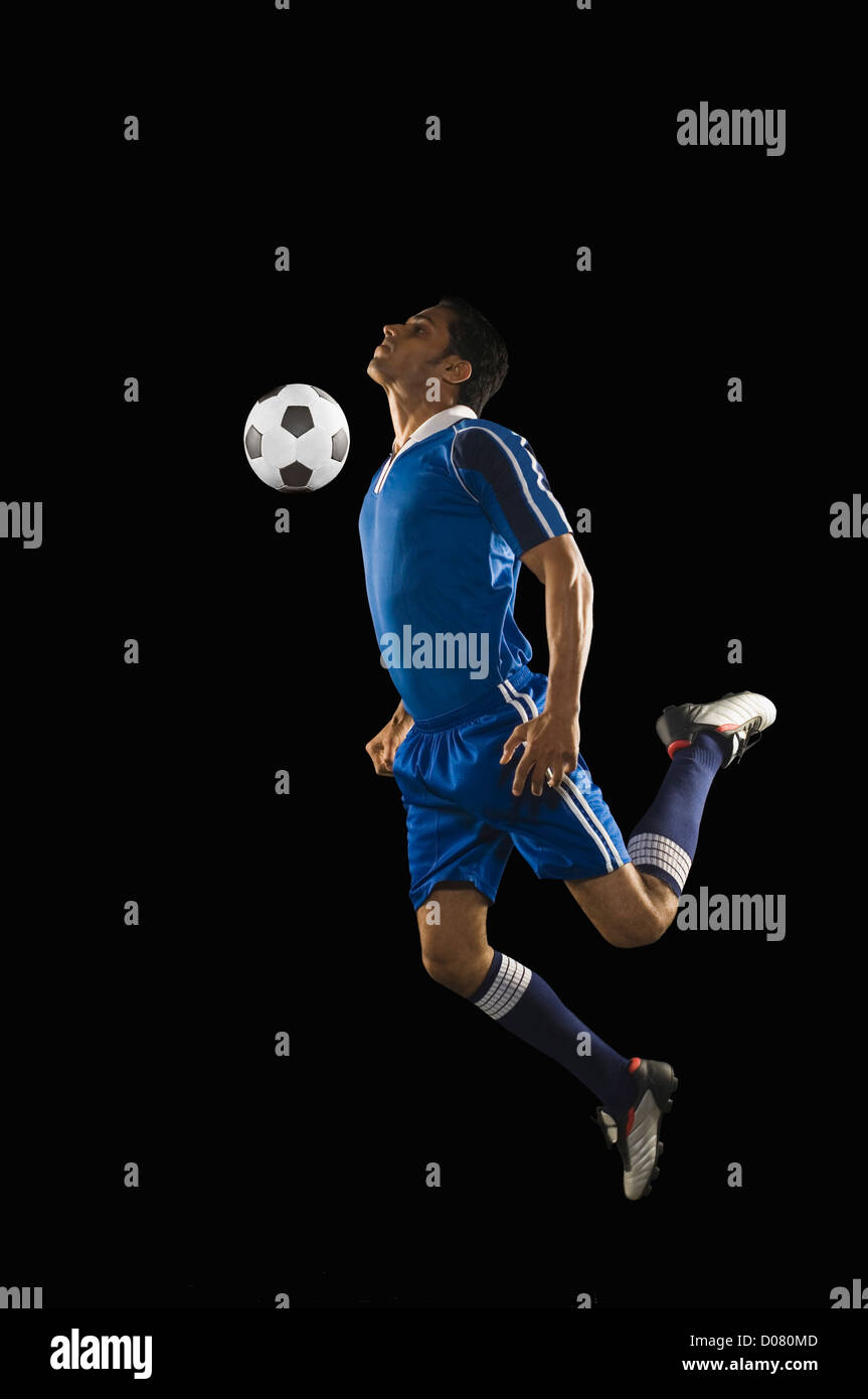 Man playing soccer Stock Photo - Alamy