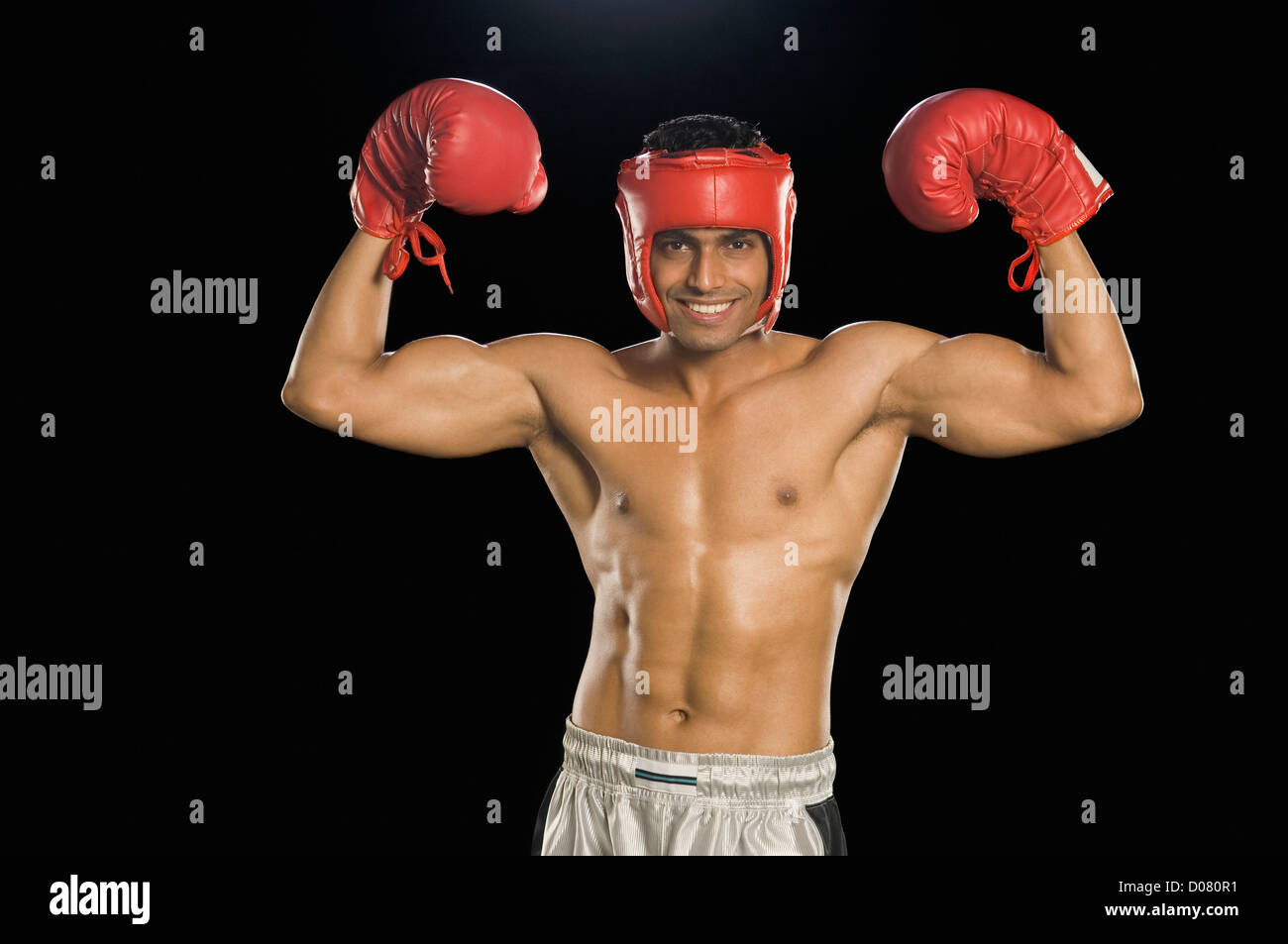 Boxer with arms raised in celebration Stock Photo - Alamy