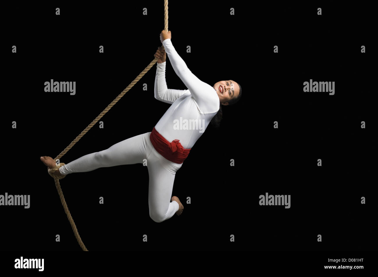 Acrobat performing on a rope Stock Photo - Alamy