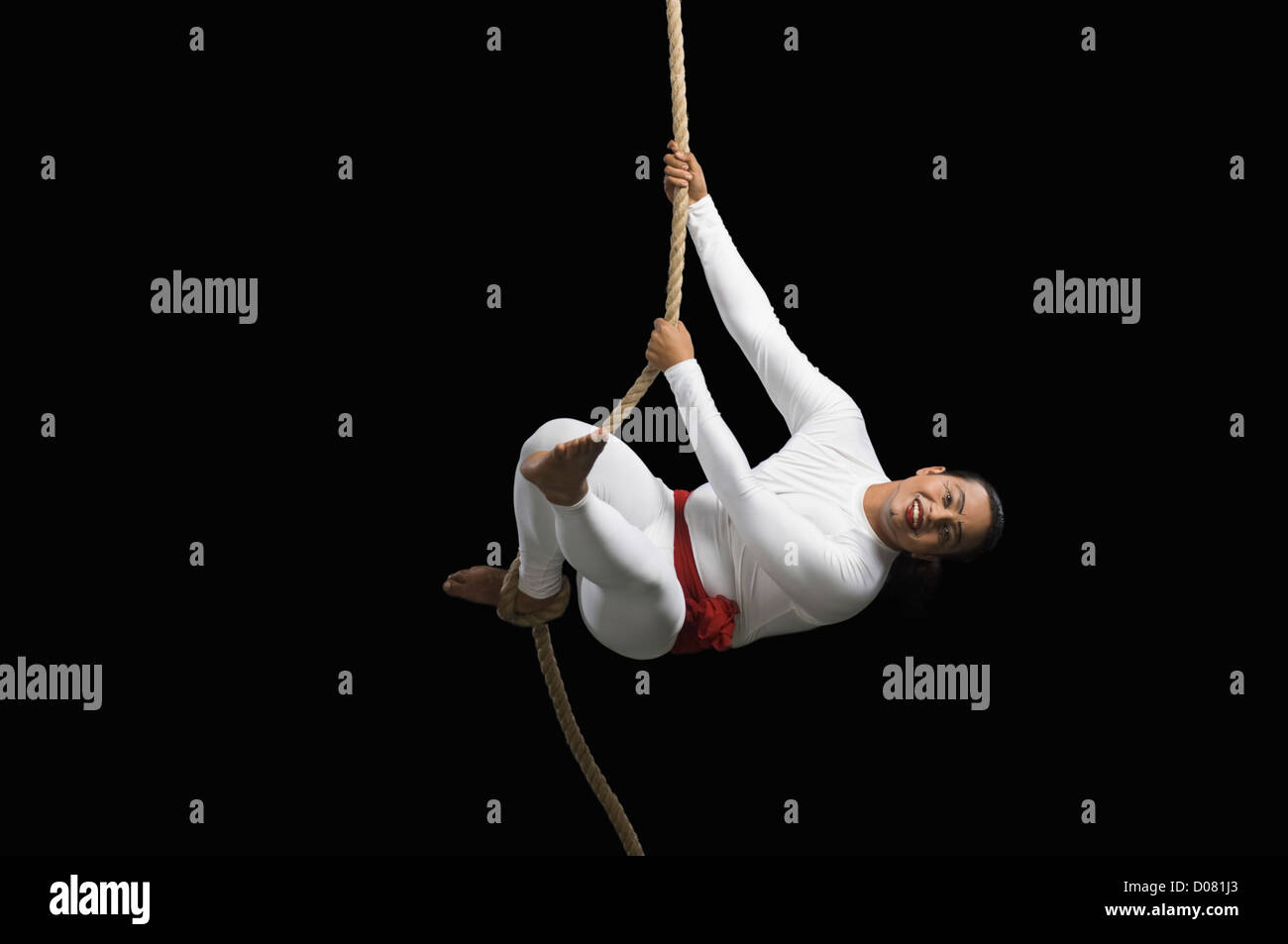 Acrobat performing on a rope Stock Photo - Alamy