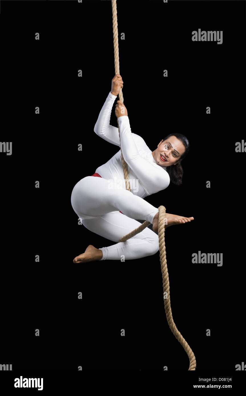 Acrobat performing on a rope Stock Photo - Alamy