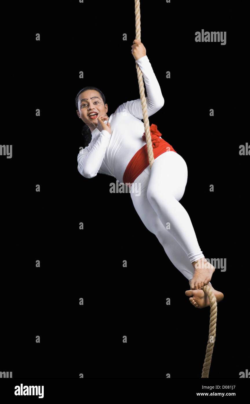 Acrobat performing on a rope Stock Photo - Alamy