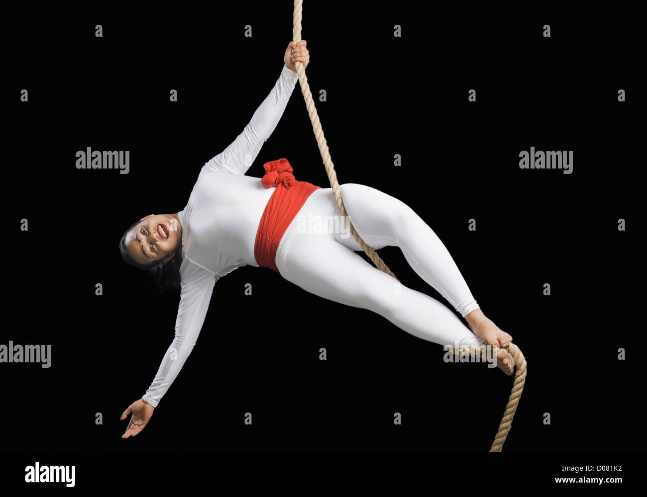 Acrobat performing on a rope Stock Photo - Alamy