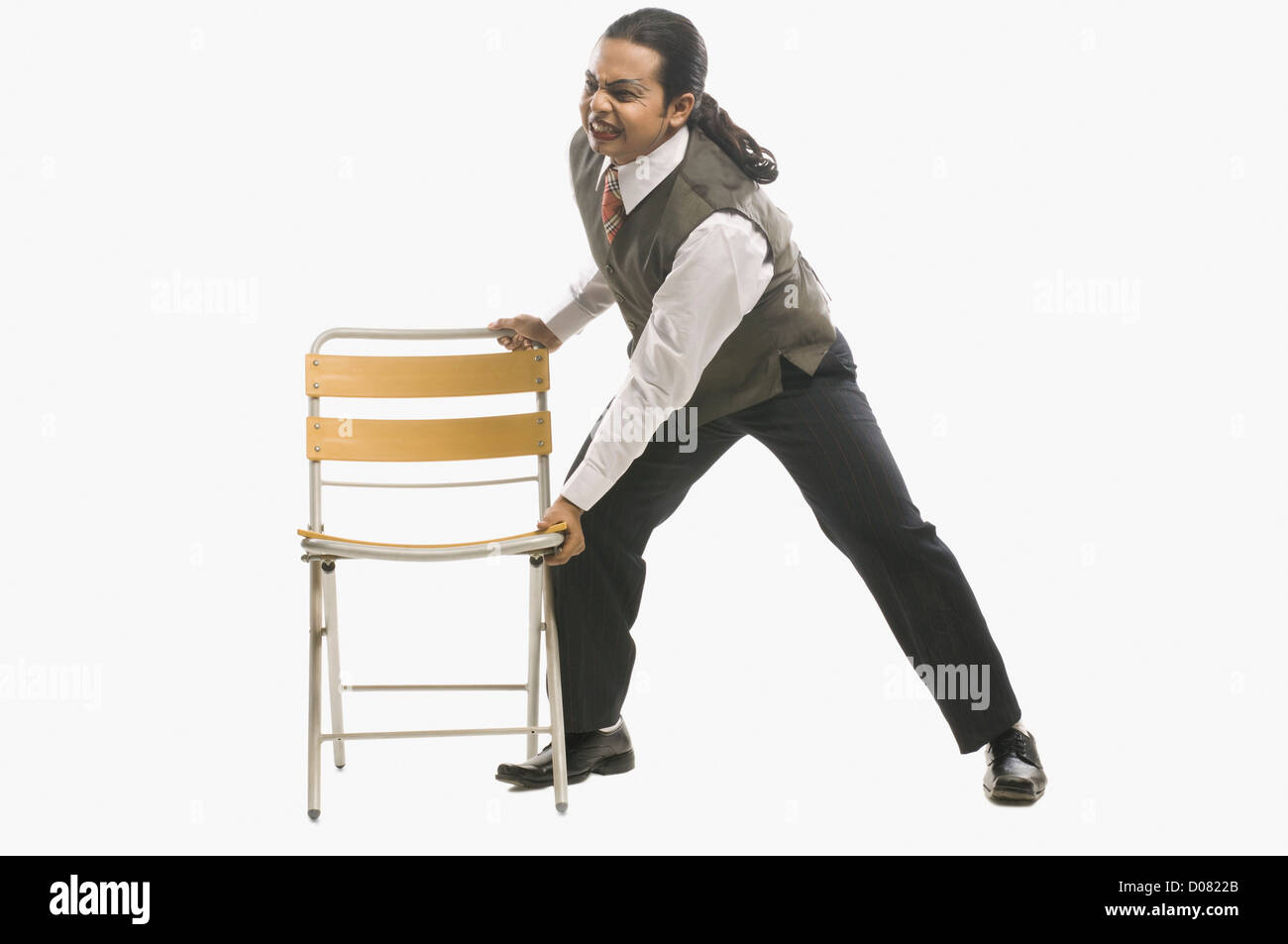 Mime holding a chair Stock Photo - Alamy