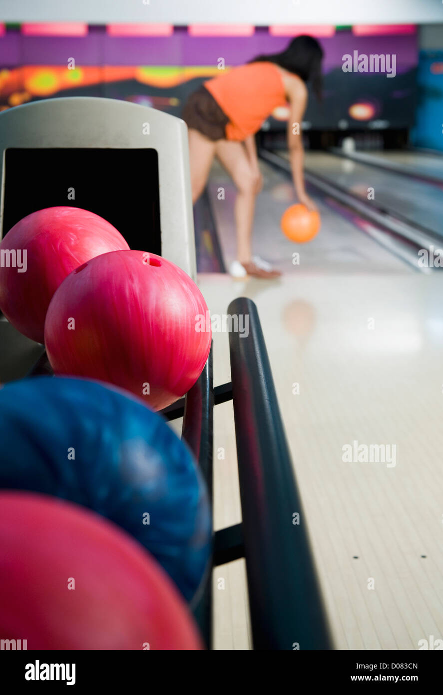 Bowling balls arranged on a rack in a bowling alley Stock Photo - Alamy