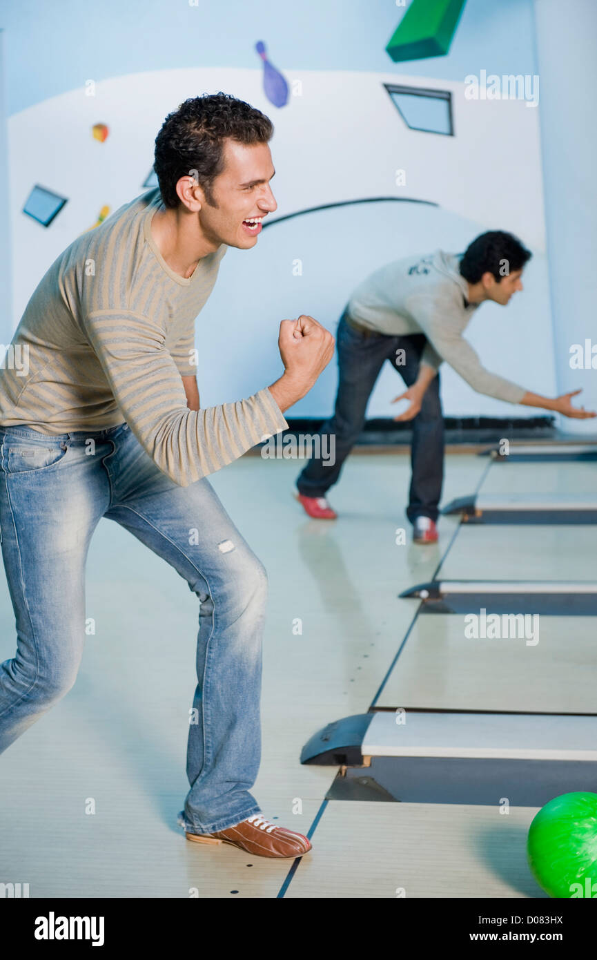 Two young men bowling in a bowling alley Stock Photo - Alamy