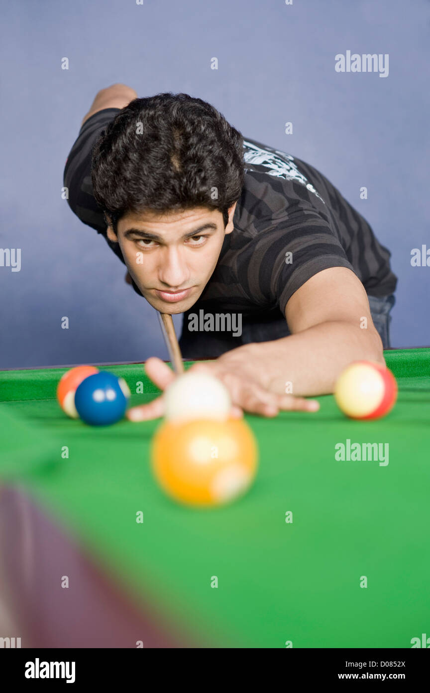 Young man playing pool Stock Photo - Alamy