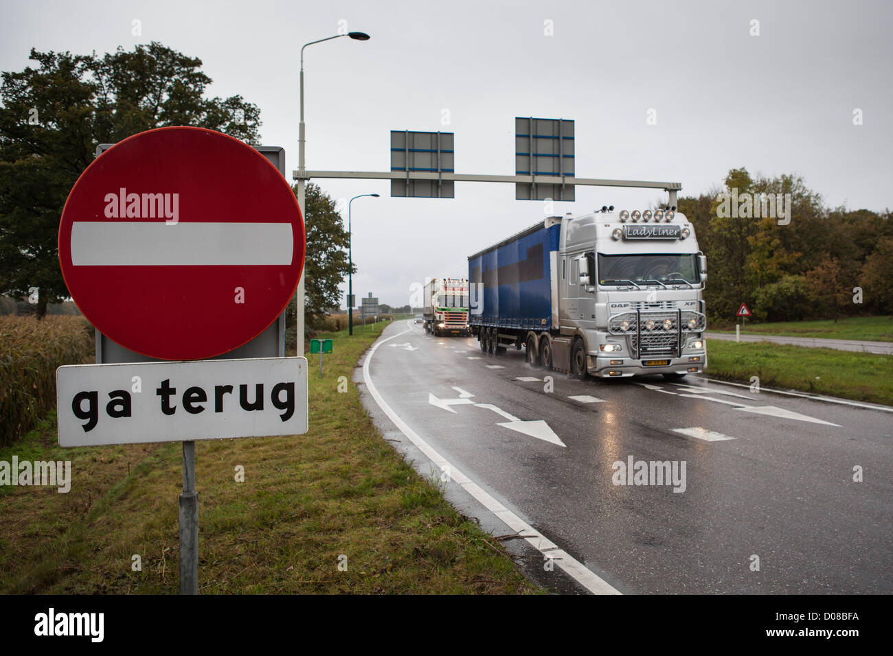 Trucks leaving motorway A67 on a rainy day in the Netherlands, Europe ...
