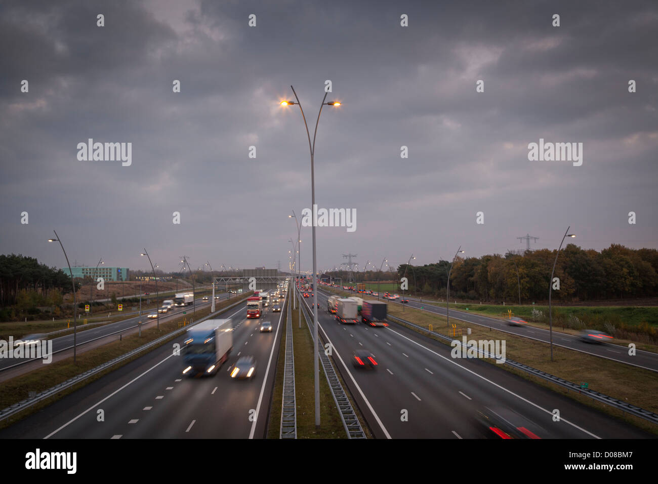 Dutch Highway A67 with trucks and traffic at night at Eindhoven in the ...