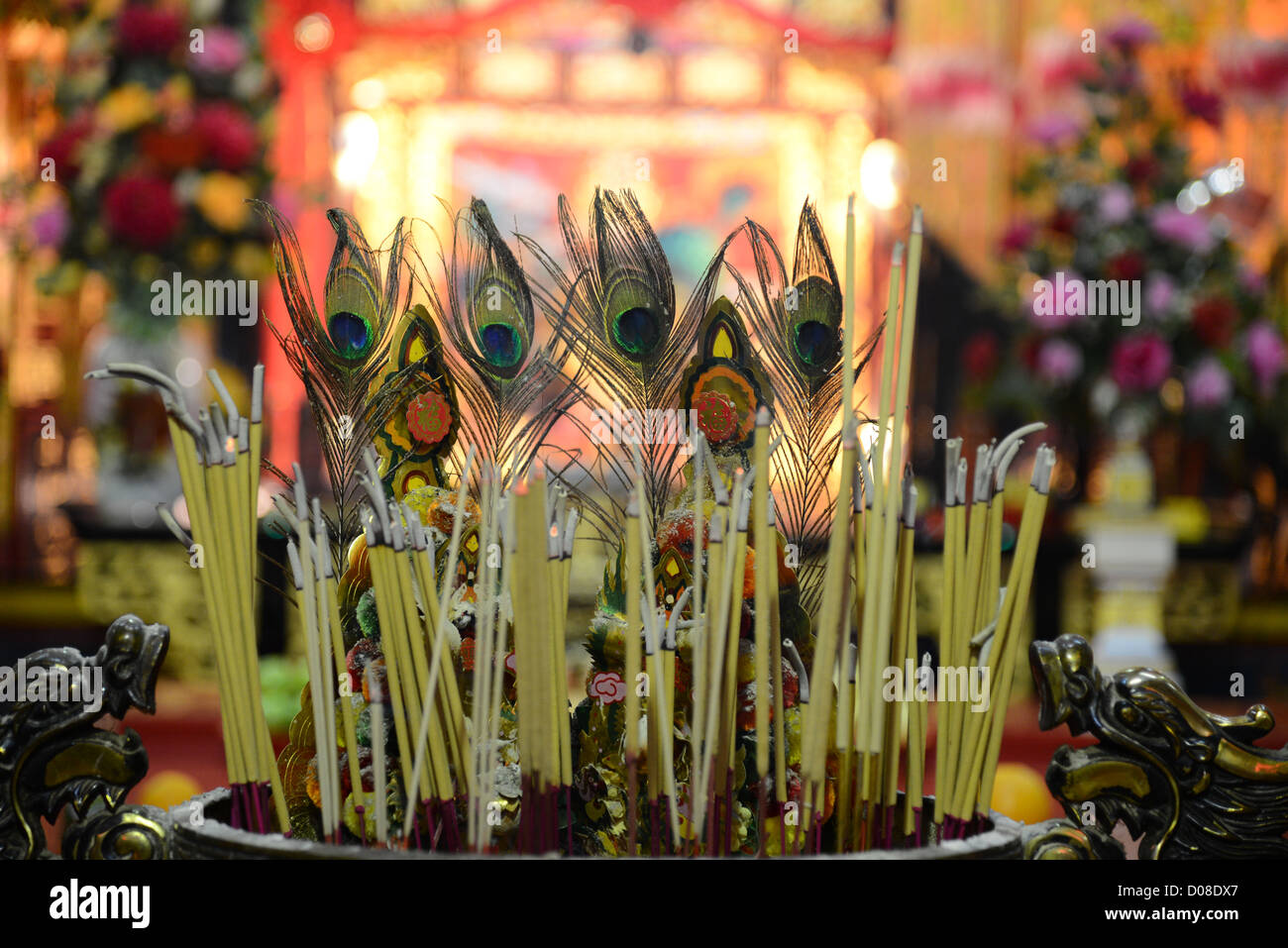 Peacock feathers and candles in a Chinese temple Stock Photo - Alamy