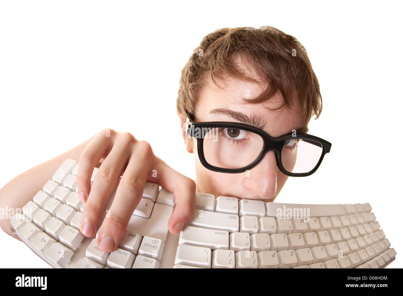 Teen hides behind a computer keyboard over white background Stock Photo ...