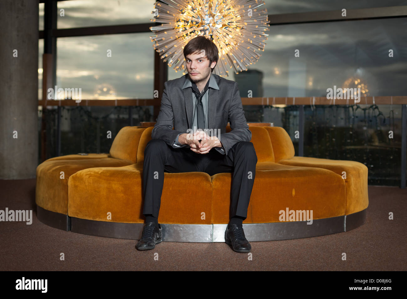 Young corporate executive sitting in luxurious interior Stock Photo - Alamy