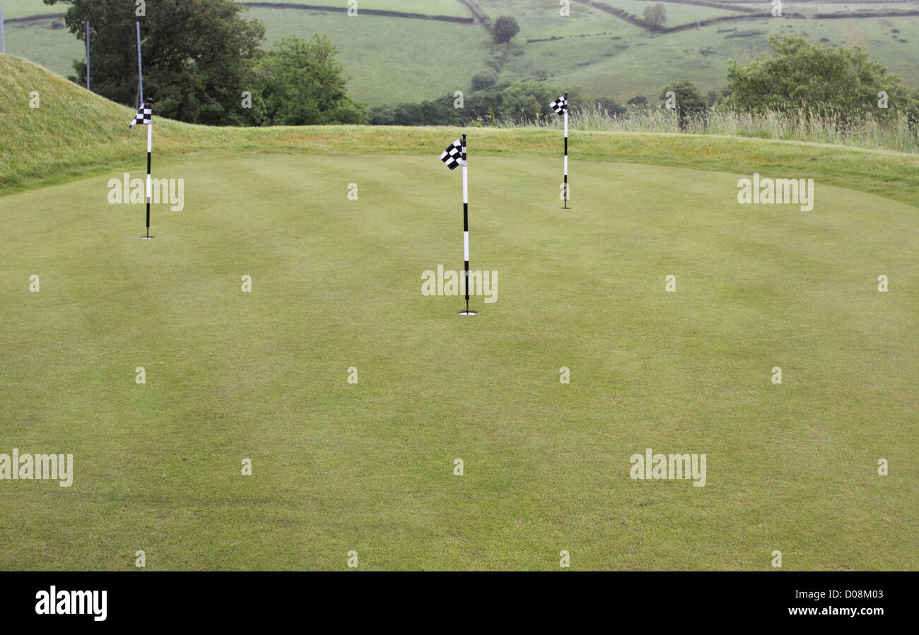 Golfers practice green Stock Photo - Alamy