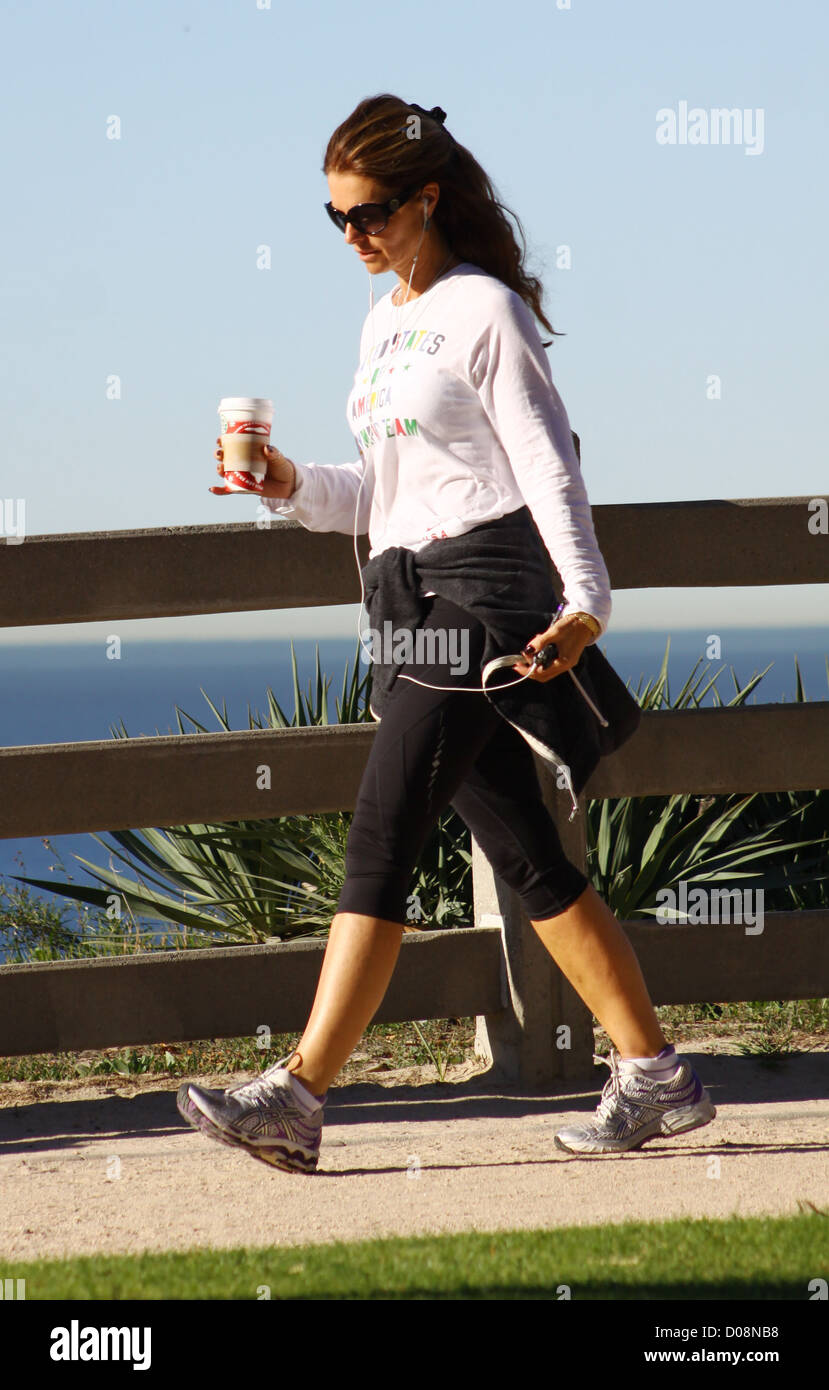 Maria Shriver carrying a cup of coffee while out jogging at the park in ...