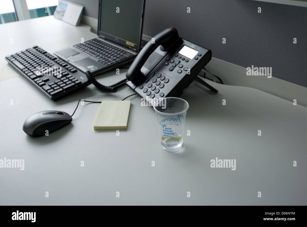 Tidy work station in share office on Grey desk by a window and an empty ...
