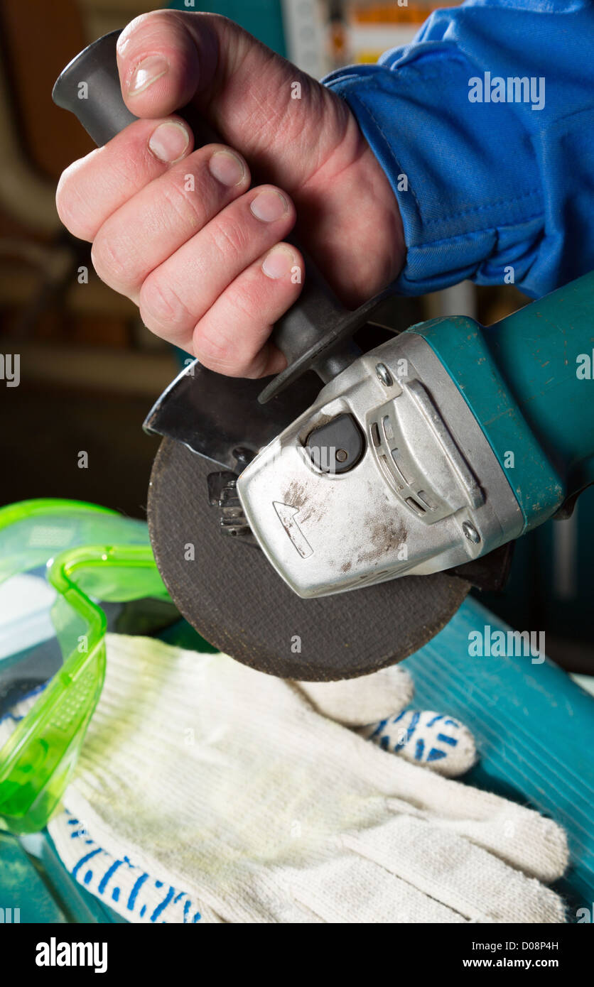 Male hand holding grinding machine Stock Photo - Alamy
