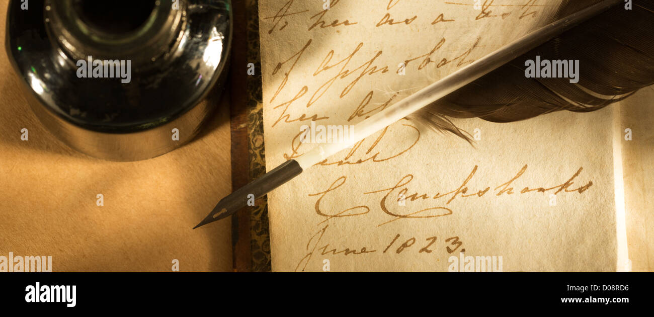 Old book with feather and inkpot Stock Photo - Alamy