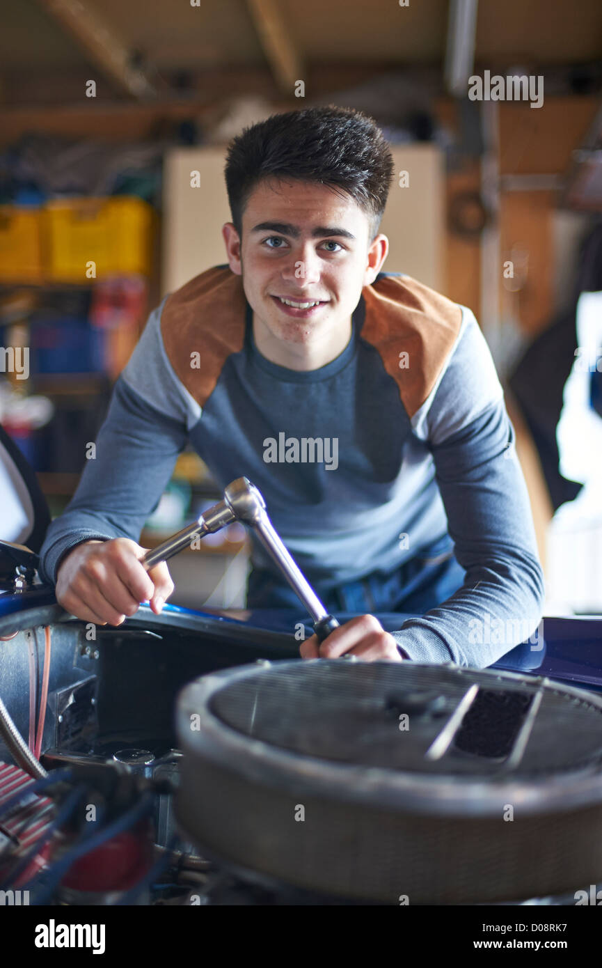 Teenage boy working on sports car in garage Stock Photo - Alamy