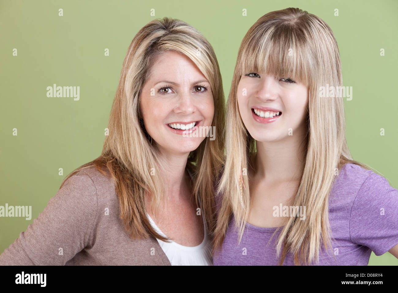 Happy Caucasian mother and daughter smile over green background Stock ...