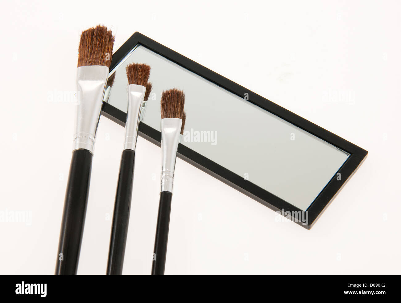 Mirror and brush set for touch-ups Stock Photo - Alamy