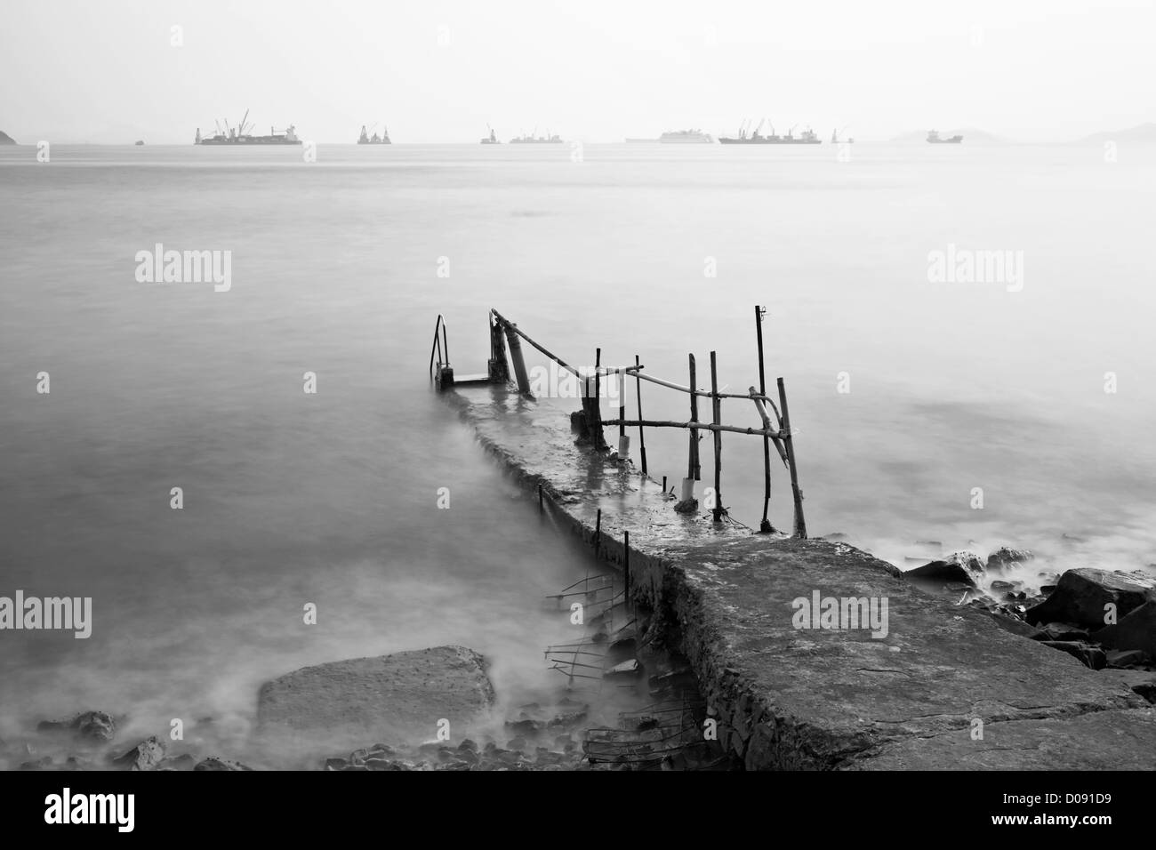 Jetty on sea at sunset Stock Photo - Alamy