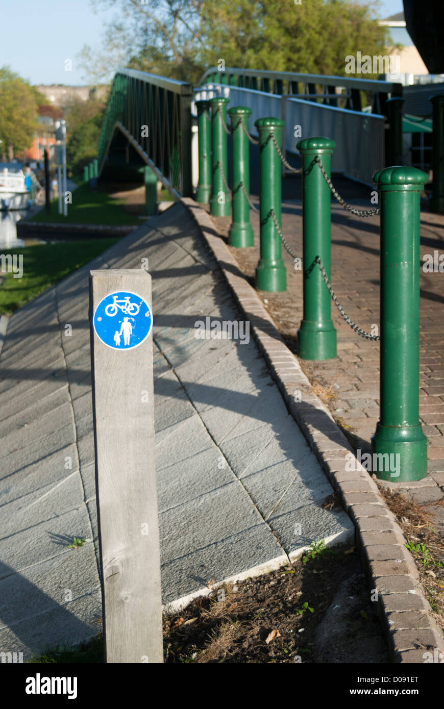 Pedestrian and cyclist pathway sign at the end of a footbridge over the ...