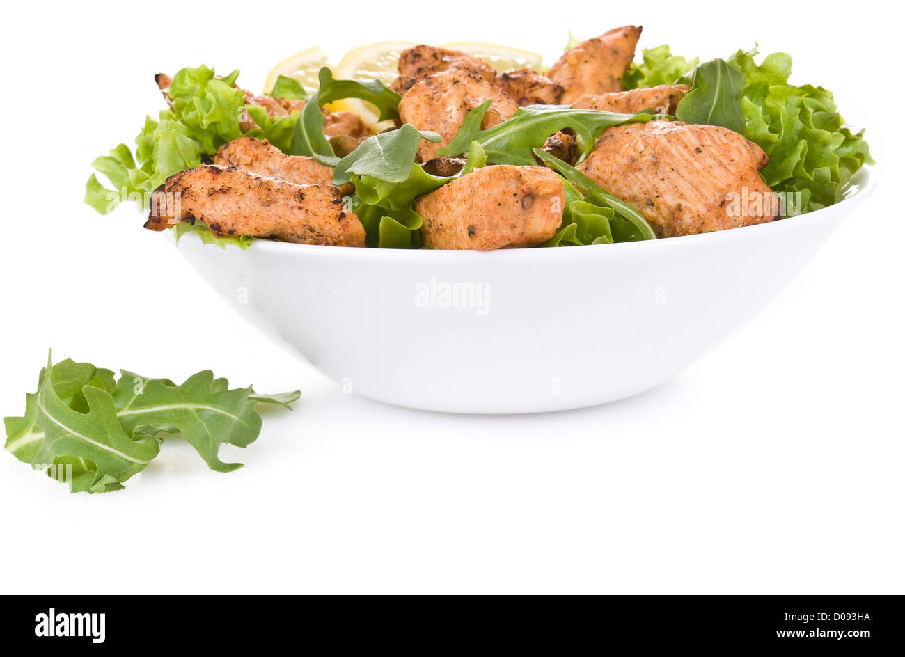 Chicken salad with dropped leaves over white background Stock Photo - Alamy