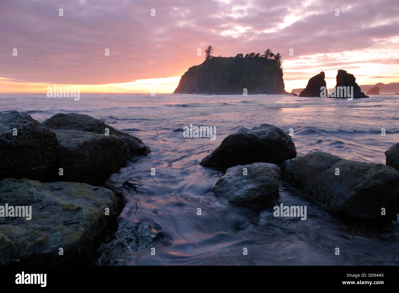WA06665-00...WASHINGTON - Sun setting behind an offshore island from ...