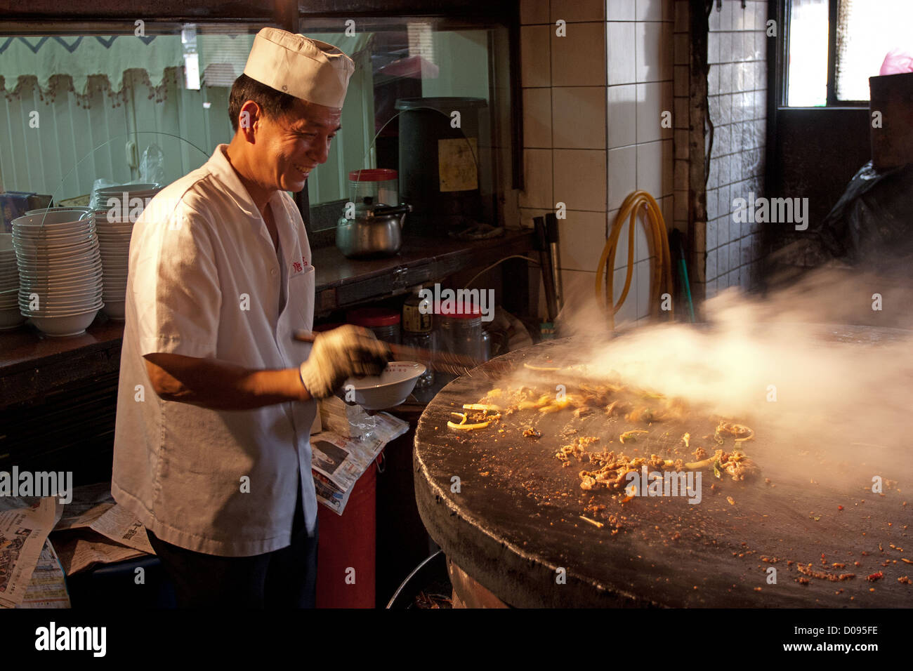 COOK PREPARING A MONGOLIAN BARBECUE IN A RESTAURANT IN TAIPEI TAIWAN ...