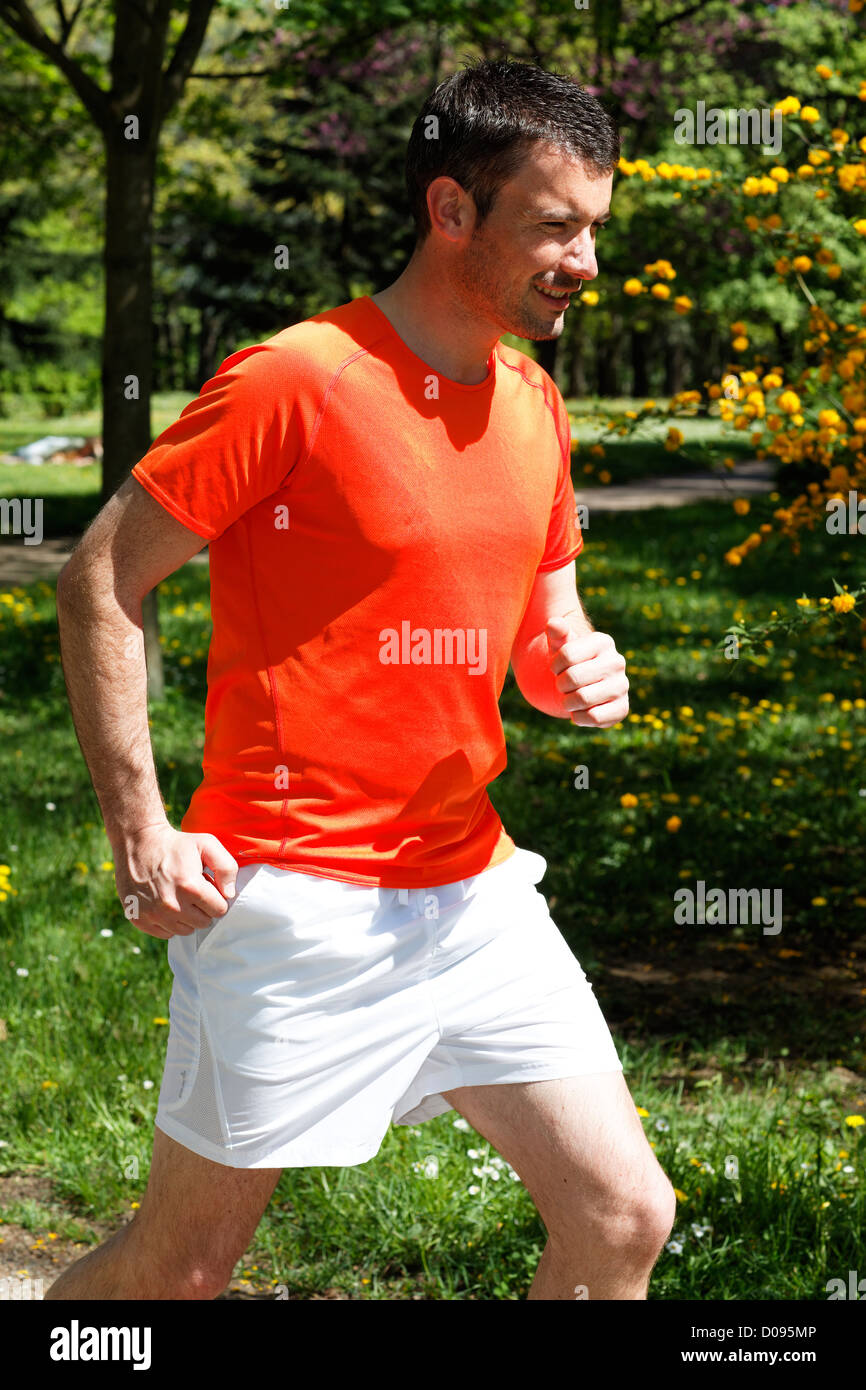 man running in a park in spring Stock Photo - Alamy