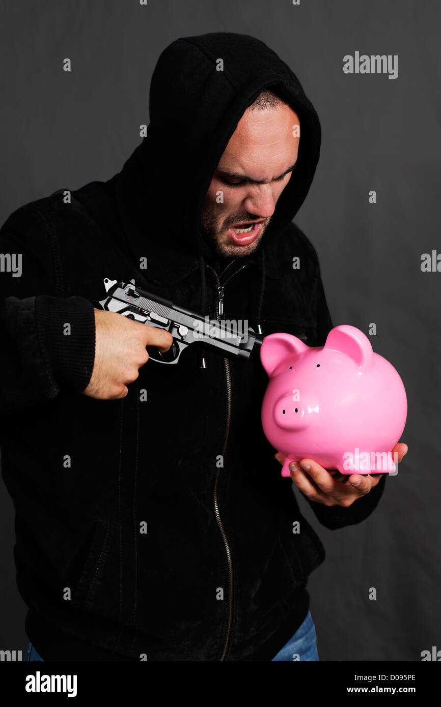 Piggy bank hand gun hi-res stock photography and images - Alamy