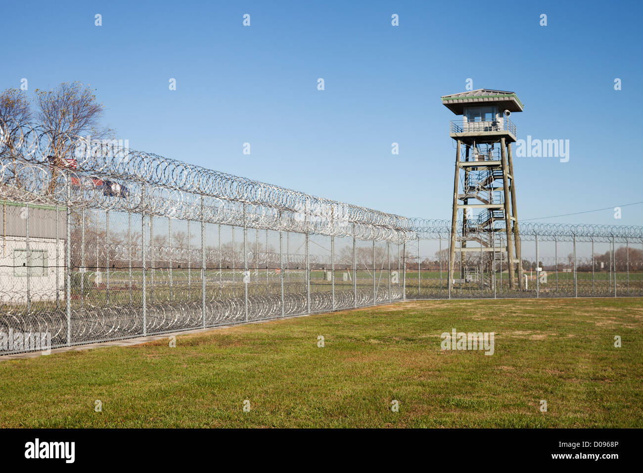 Prison fence, watch tower and barbed wire at Correctional Facility ...