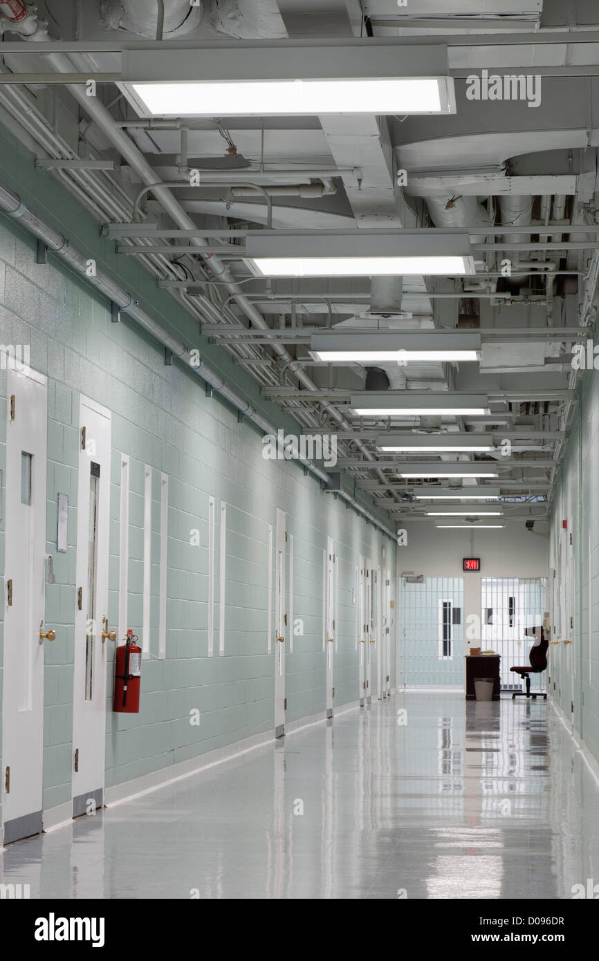 A long corridor in a residential unit Prison cell doors with ...