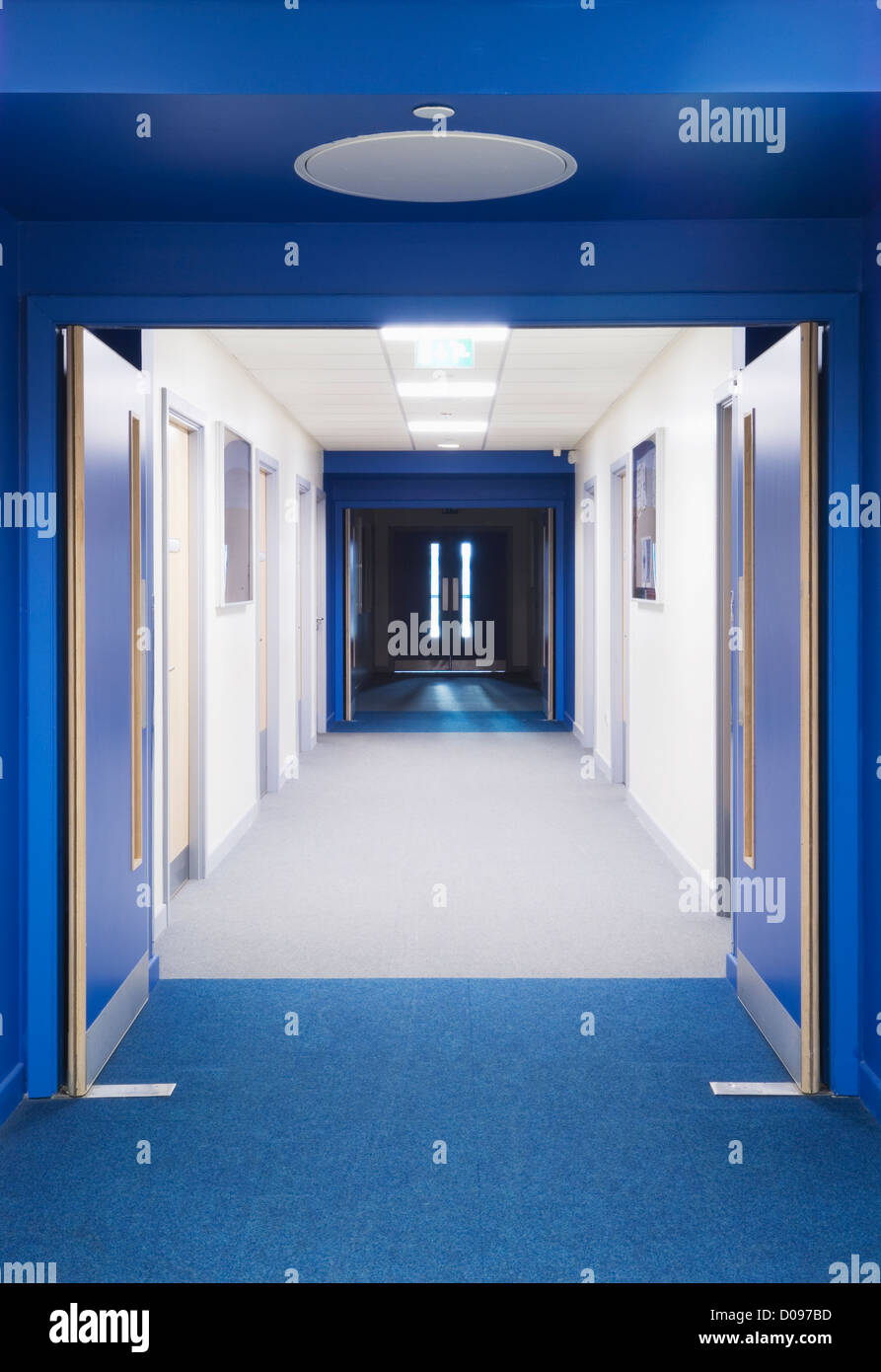 View along a corridor with blue and white walls. Doors and windows ...