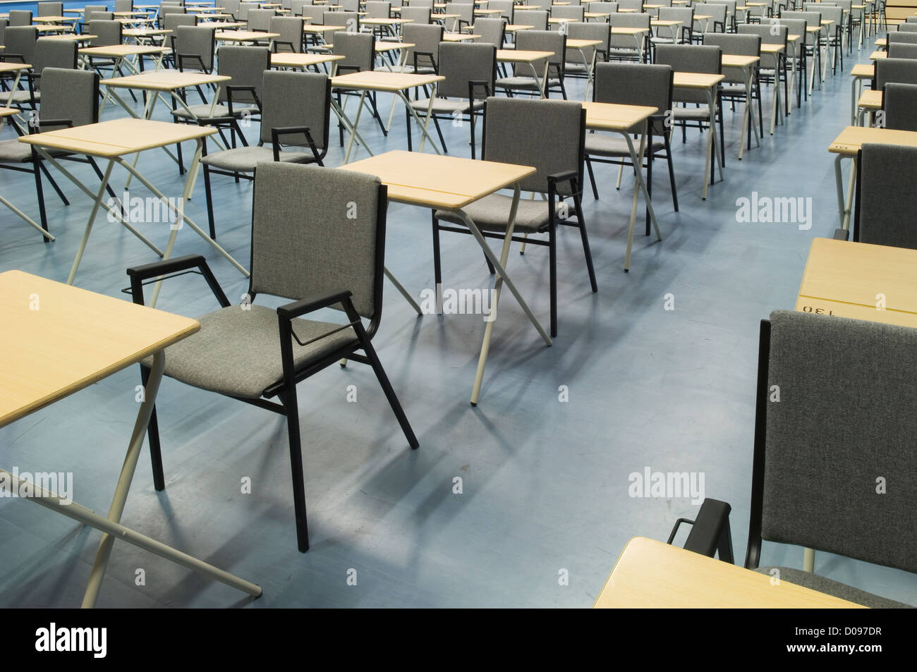 The main hall of a modern secondary school set out for exams with rows ...
