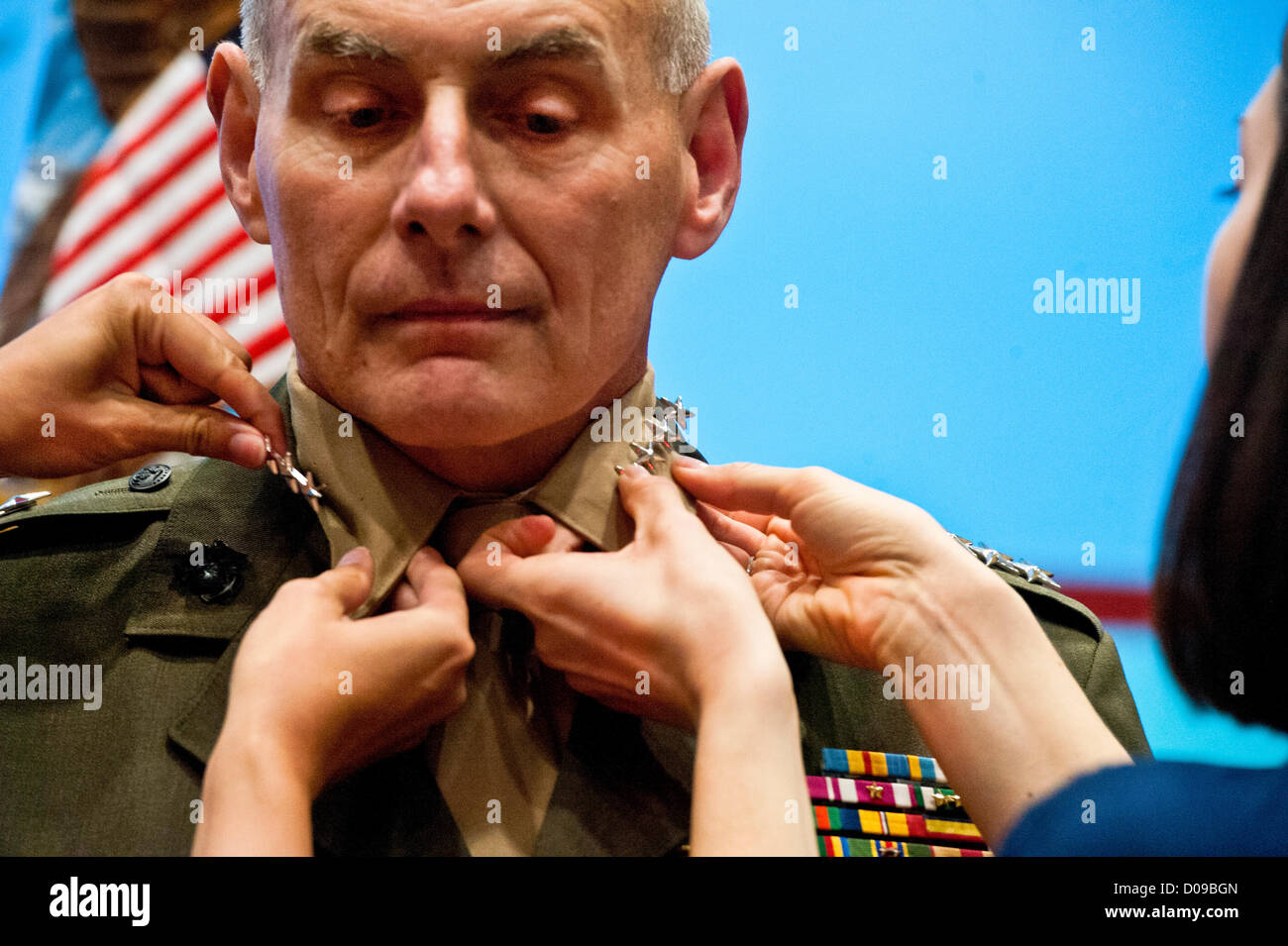 US General John Kelly has his fourth star pinned to his collar by his ...