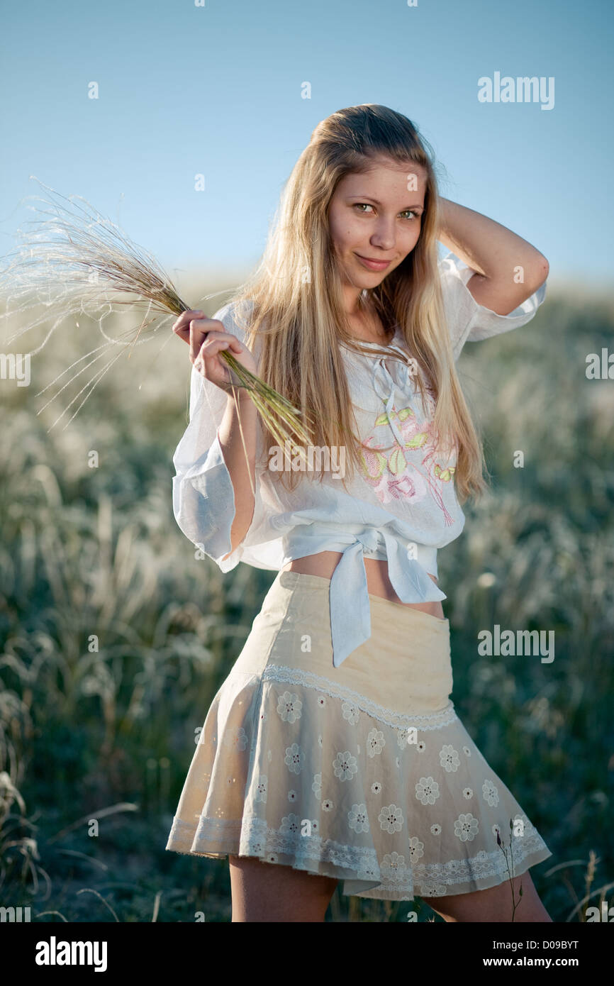 Rural girl with buch of feather grass Stock Photo - Alamy