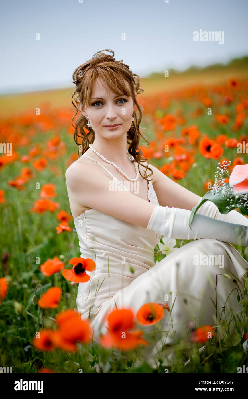 Beautiful woman in poppy field Stock Photo - Alamy