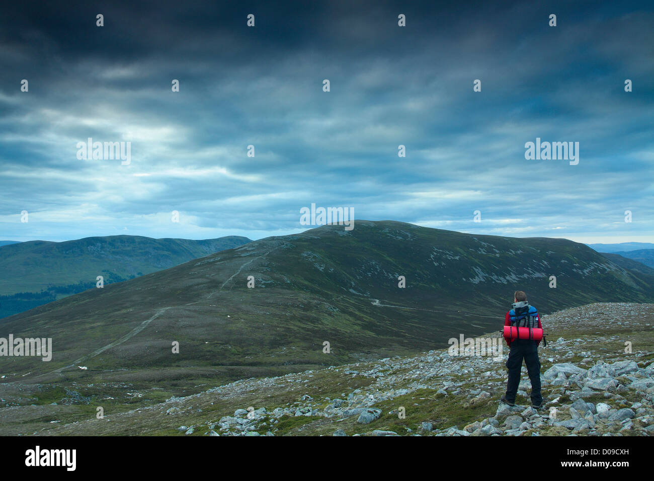 A walker looking towards the Munro of Geal Charn from A'Mharconaich ...