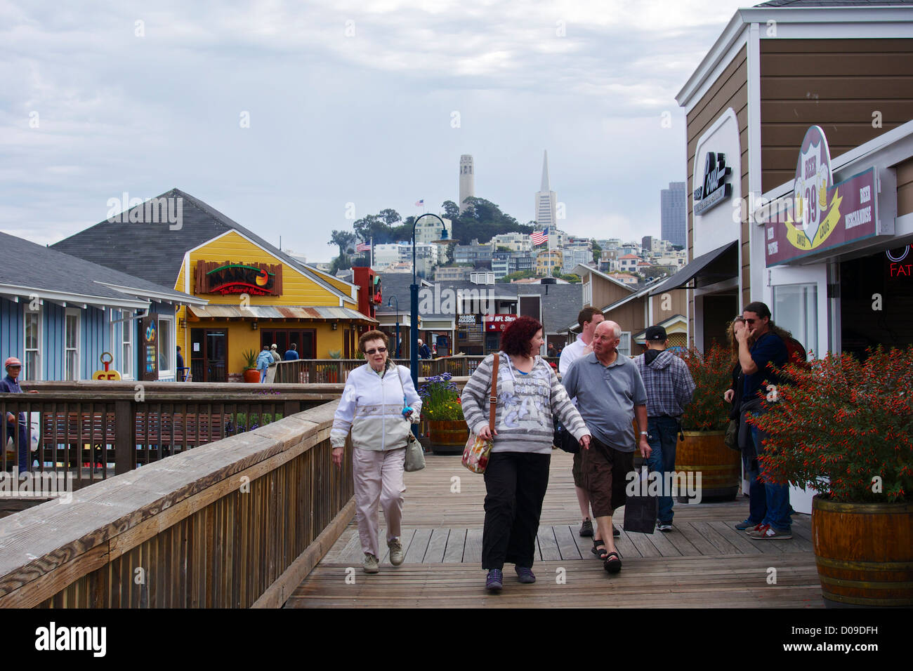 Tourists on Pier 39, Telegraph Hill and Coit Tower in background Stock ...