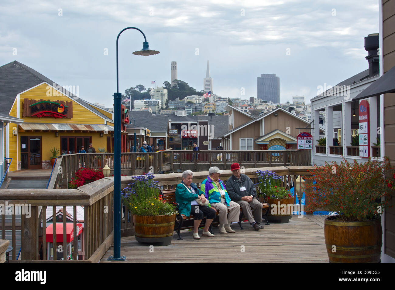Tourists on Pier 39, Telegraph Hill and Coit Tower in background Stock ...