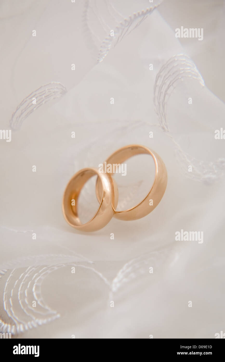 Wedding rings on veil closeup vertical Stock Photo - Alamy