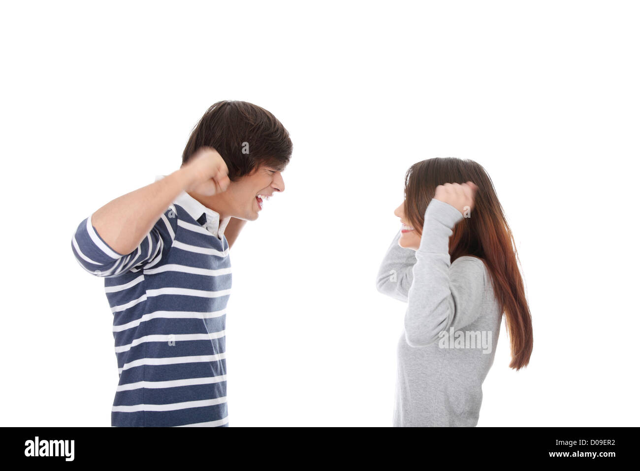 Young couple in conflict shouting each other, isolated on white ...