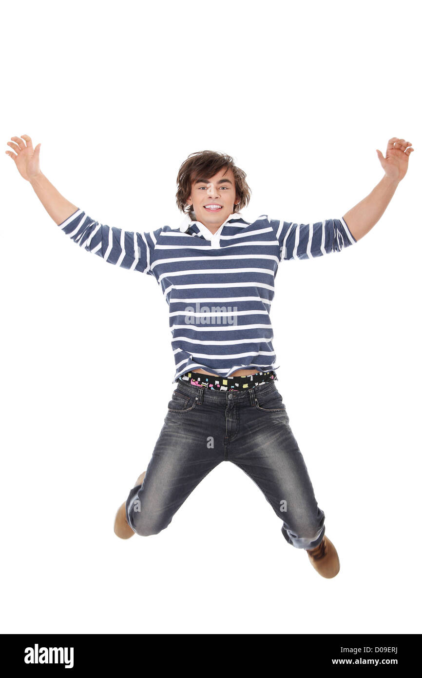 Excited young man jumping in air against white background Stock Photo ...
