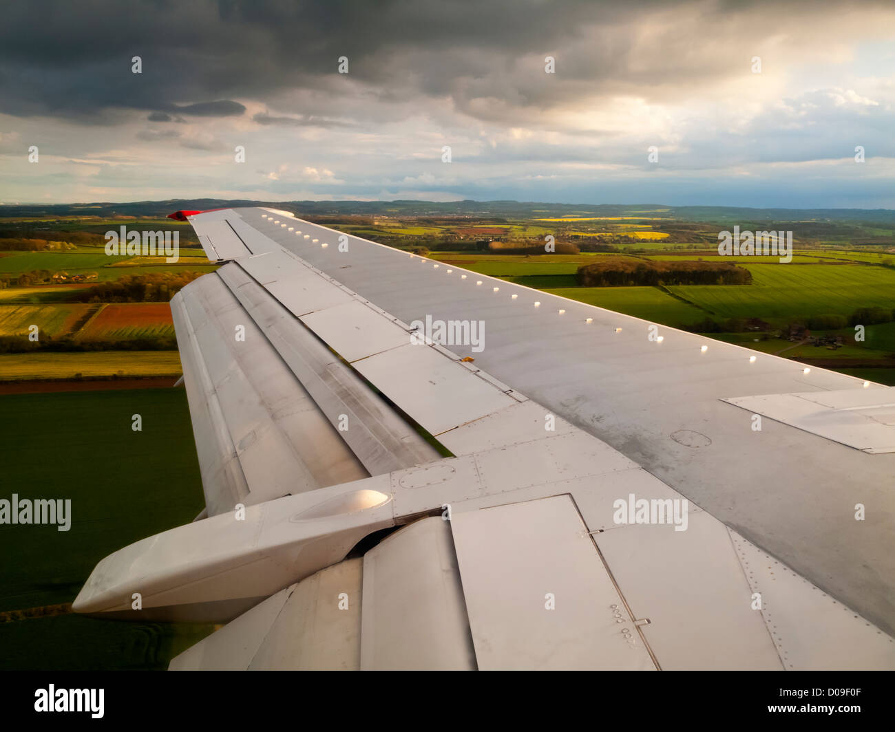 Wing of Boeing 737 passenger airliner flying low on final descent with ...