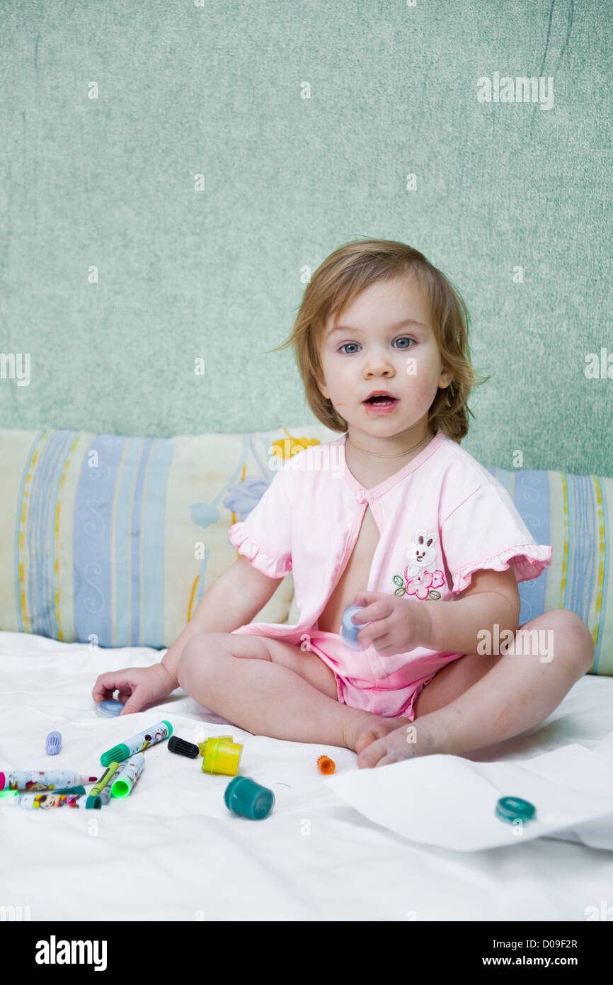 Pretty child playing and painting at home Stock Photo - Alamy
