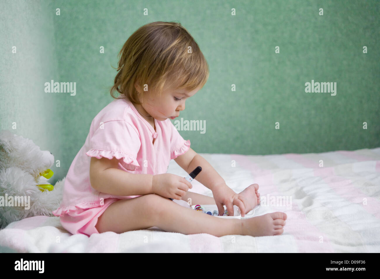 Pretty child playing and painting at home Stock Photo - Alamy