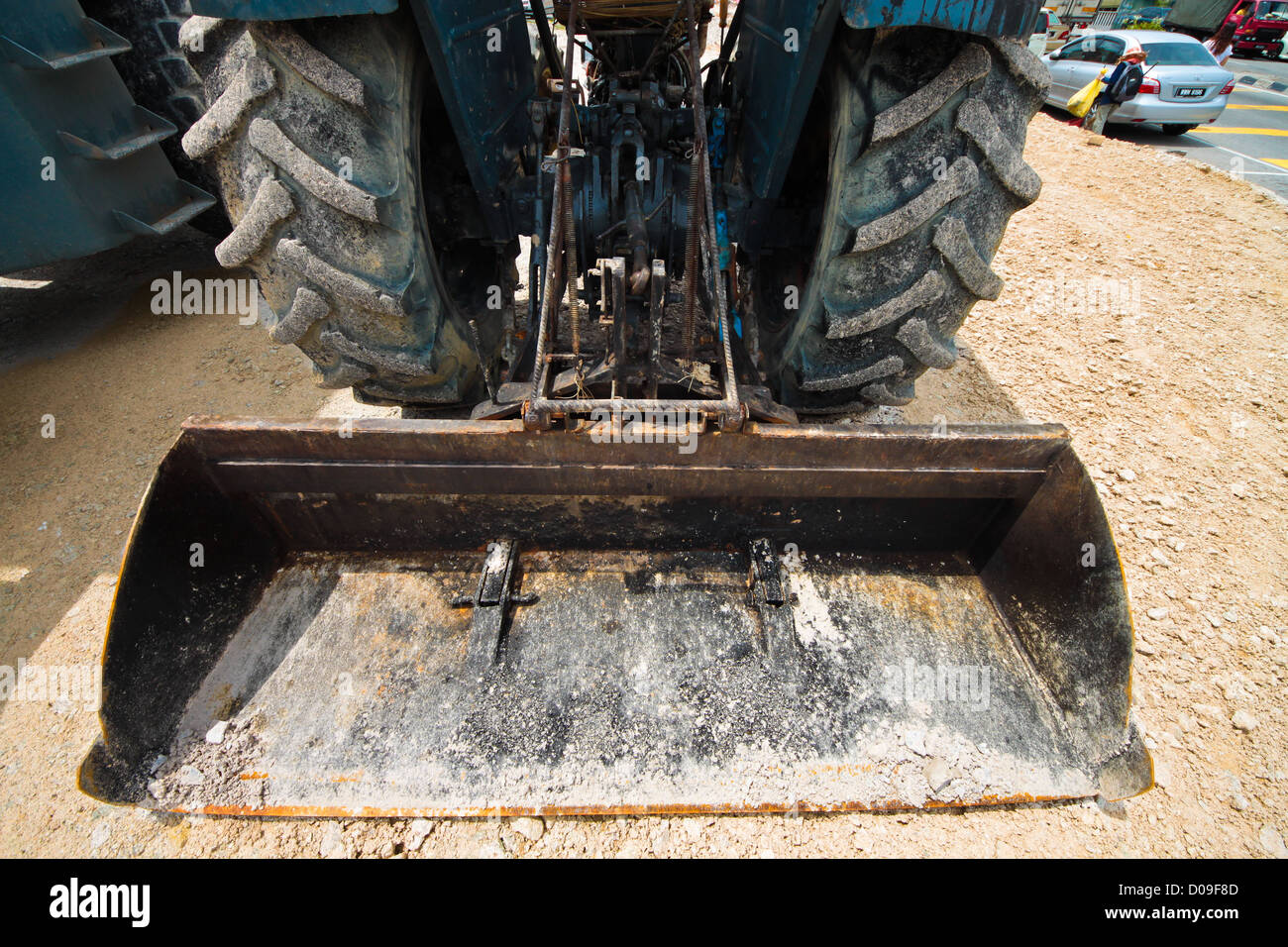 Back pusher tractor on road side Stock Photo - Alamy