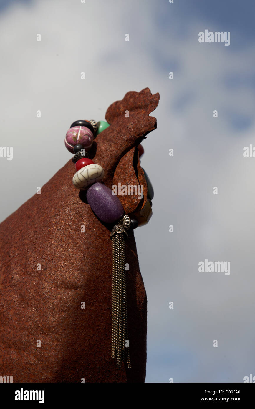 Rusty Chicken with Hand made jewellery on neck Stock Photo - Alamy